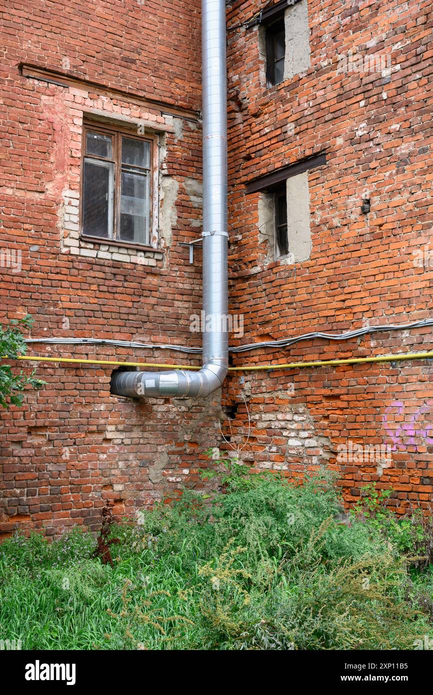Urban landscape with the wall of an old house with windows and a ...