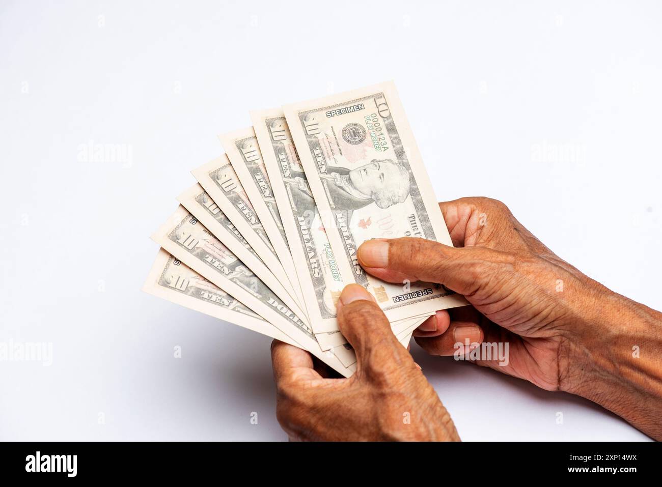 Counting US paper currency 10 dollar against white background Stock ...