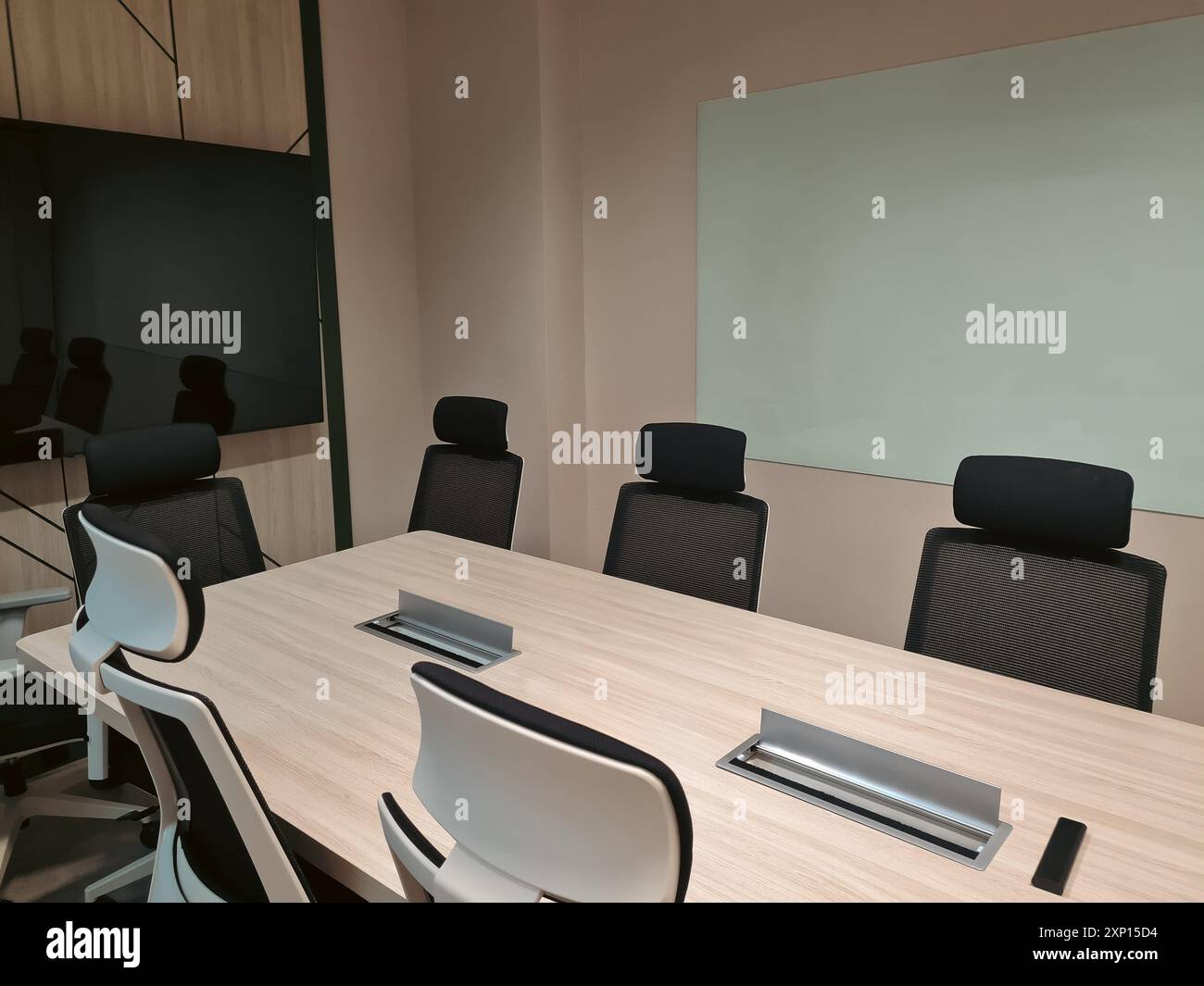 Empty small meeting room with television and white board for discussion ...