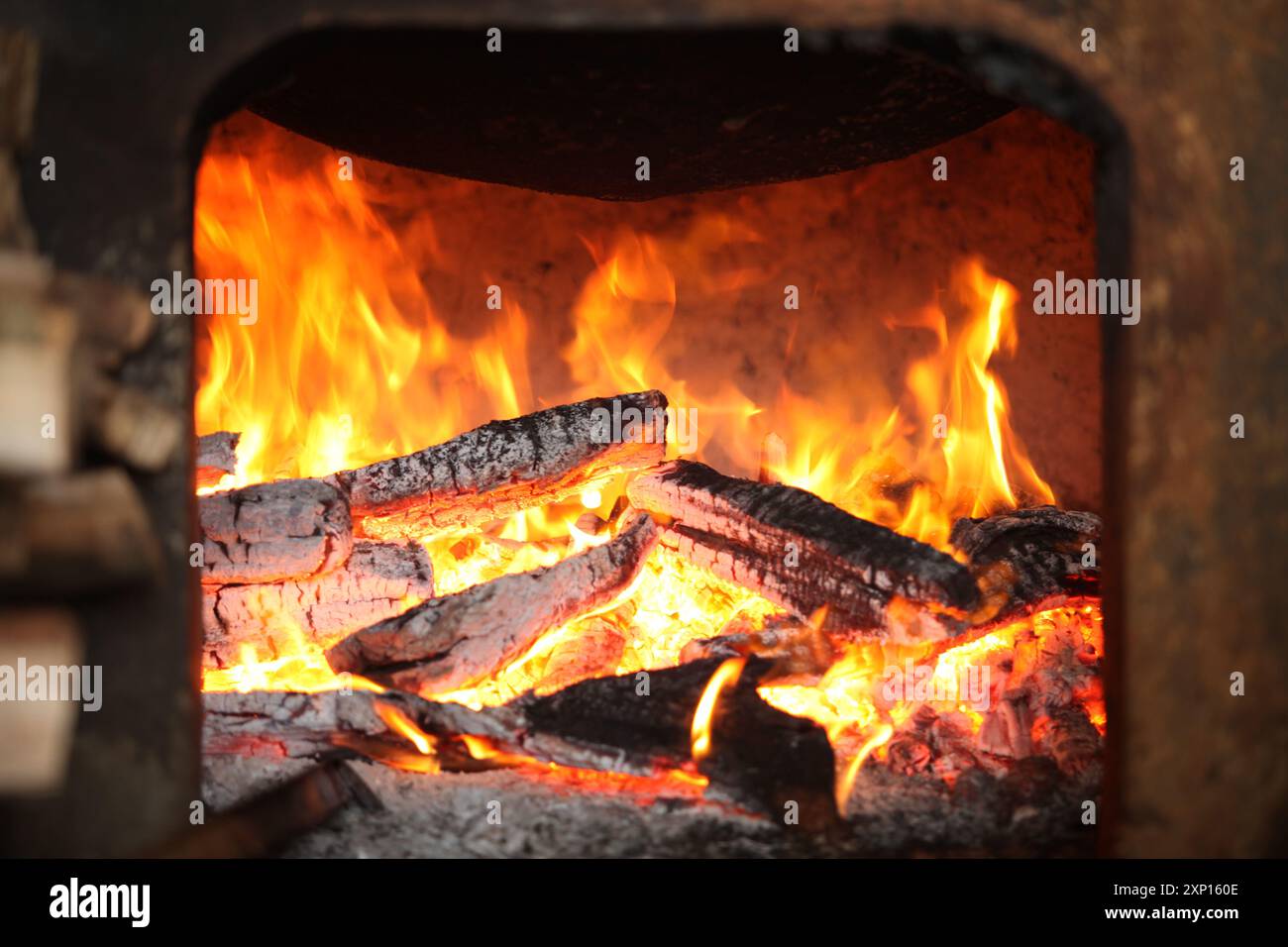 Fire wood burning in the oven Stock Photo - Alamy