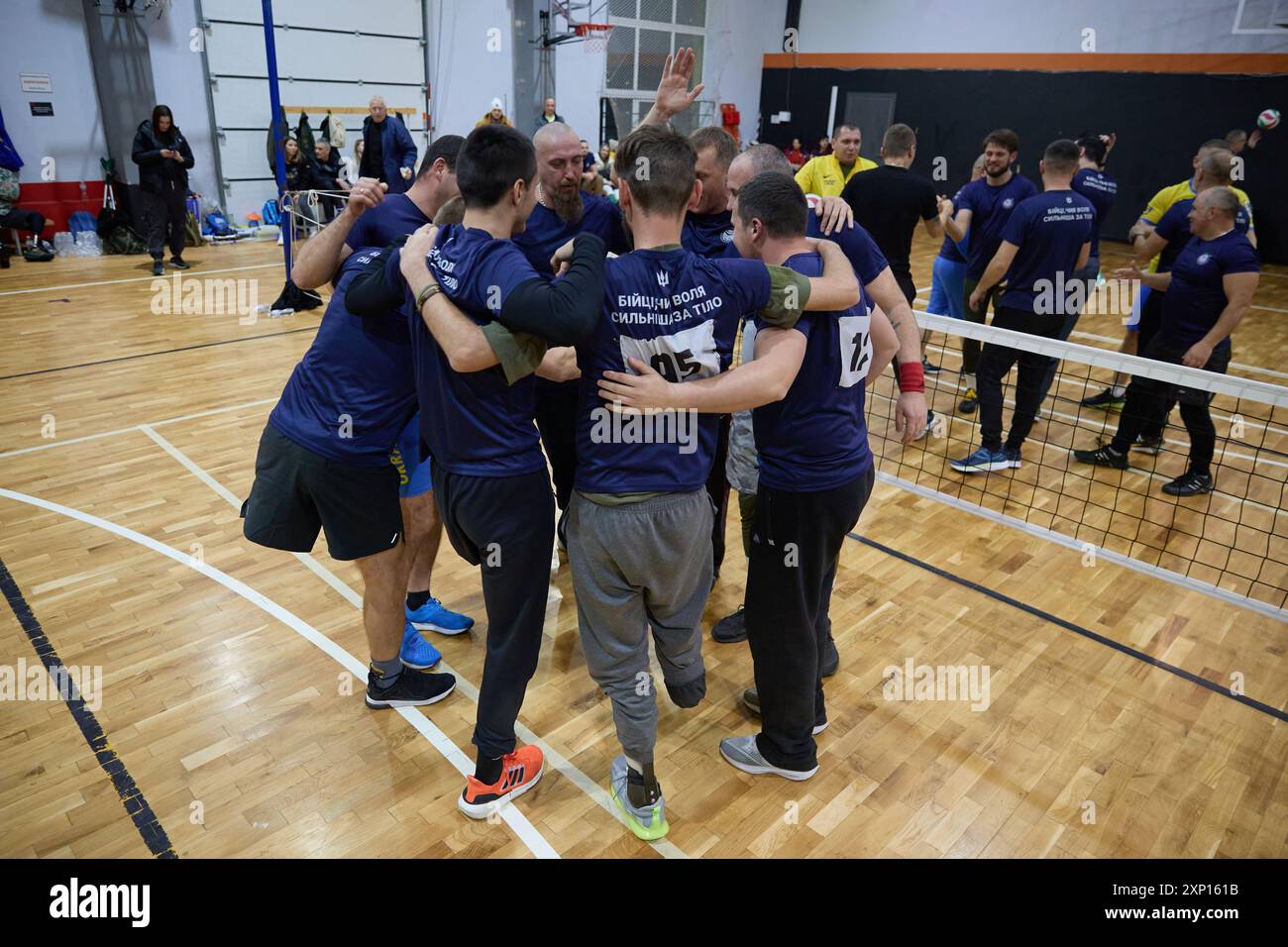Sitting volleyball team hugging before the match. Wounded soldiers ...
