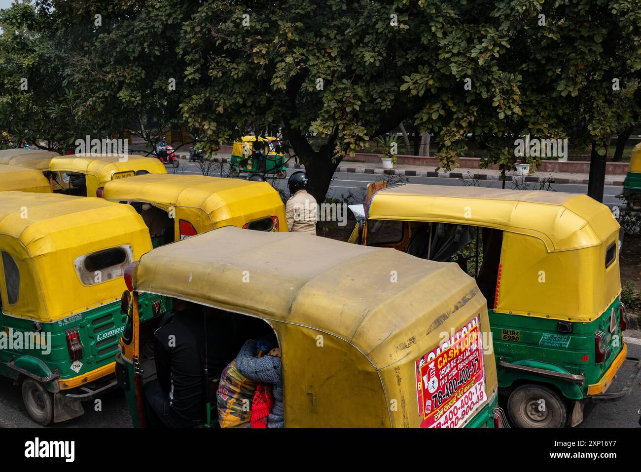 Delhi, India February 12 2024 yellow indian motorized rickshaw taxis ...