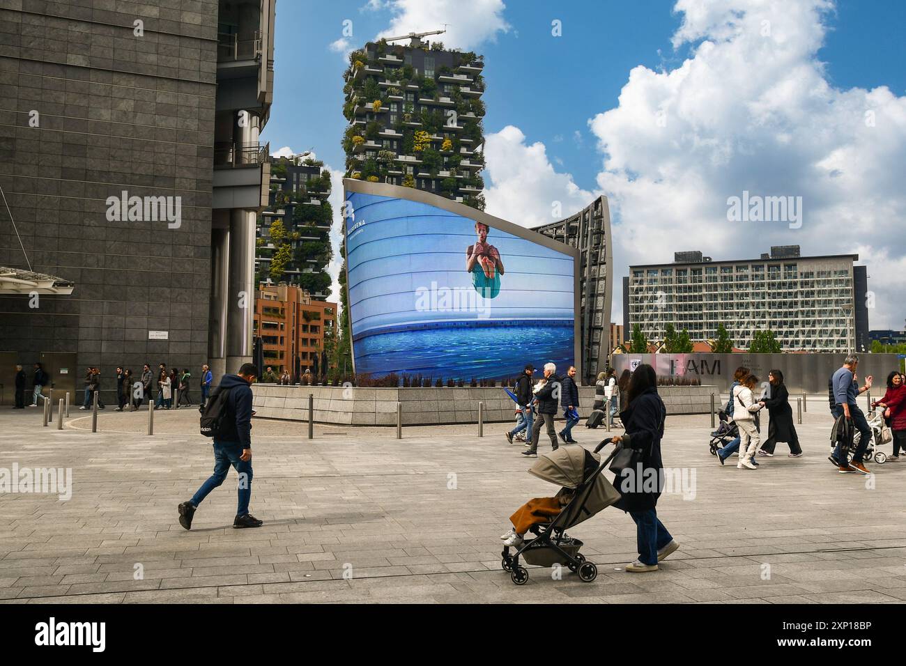 People strolling in Piazza Gae Aulenti modern square, with a giant led ...