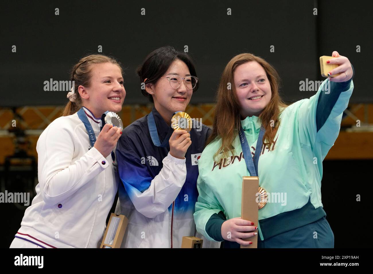 Bronze medalist Hungary's Veronika Major, right, uses her phone to take ...