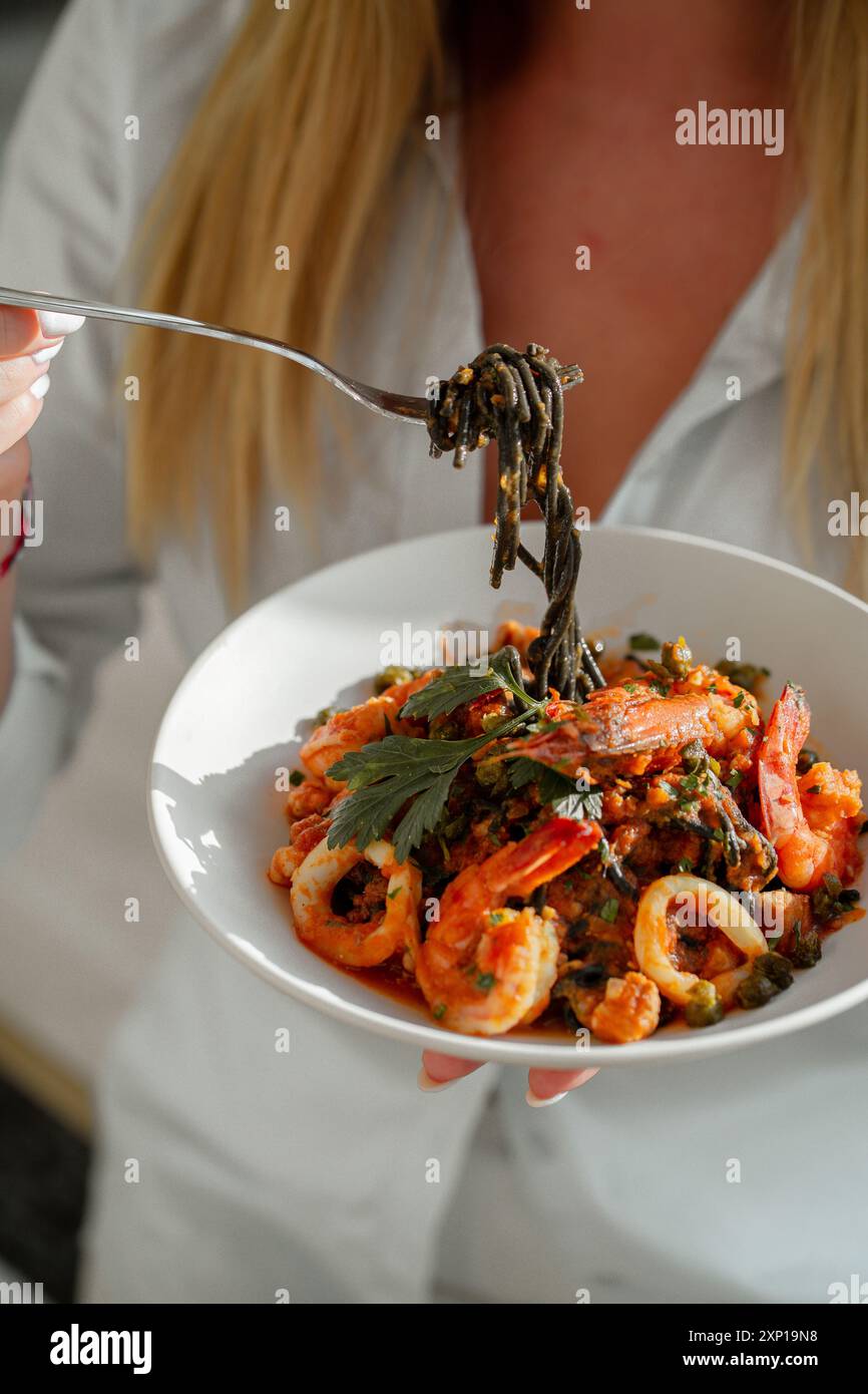 Woman eating seafood hi-res stock photography and images - Alamy