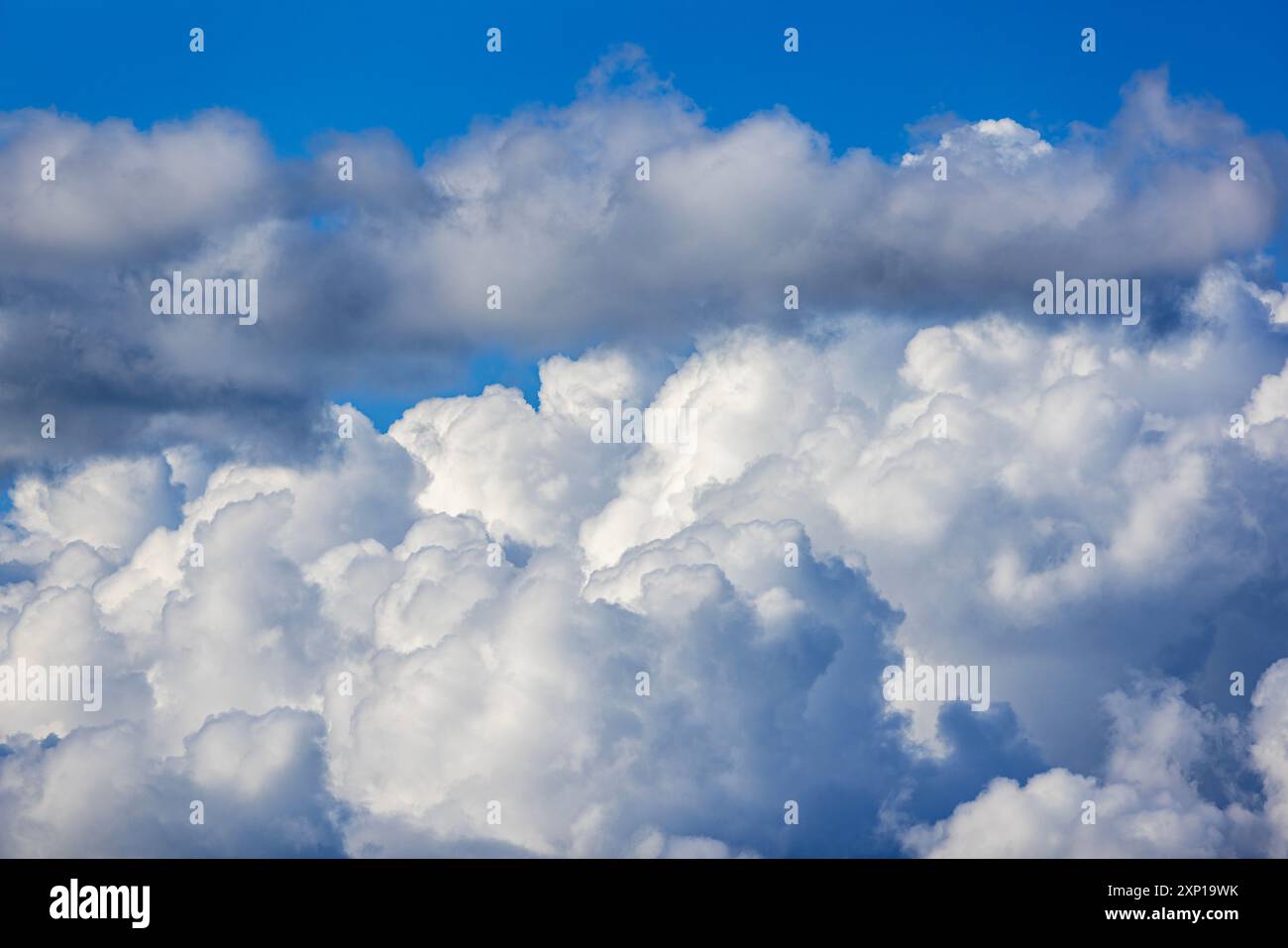Fluffy Puffy cumulus clouds against a blue sky Stock Photo - Alamy
