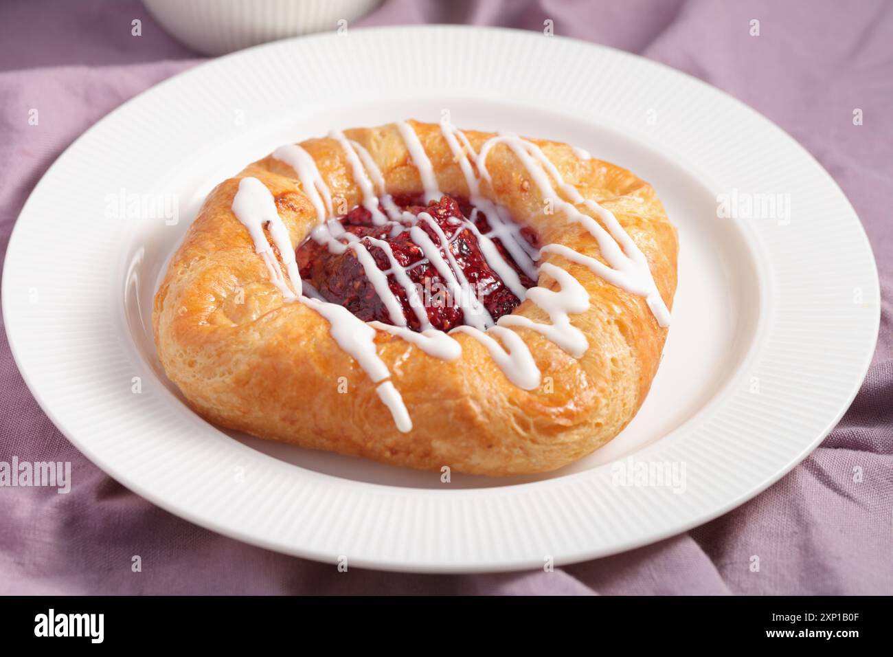 Danish pastry with raspberry jam closeup Stock Photo - Alamy