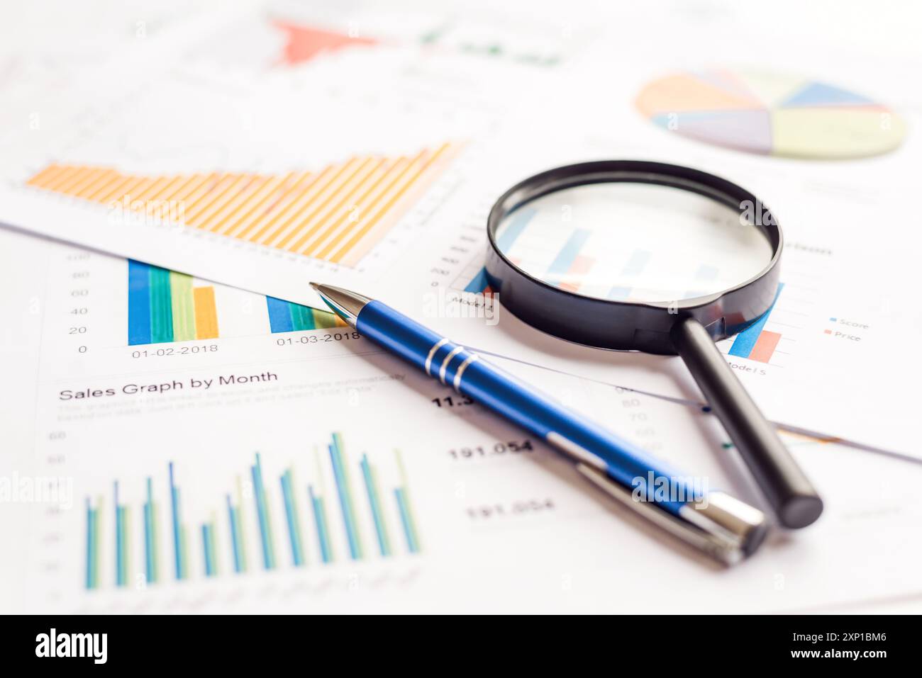 Magnifying glass on charts hi-res stock photography and images - Alamy