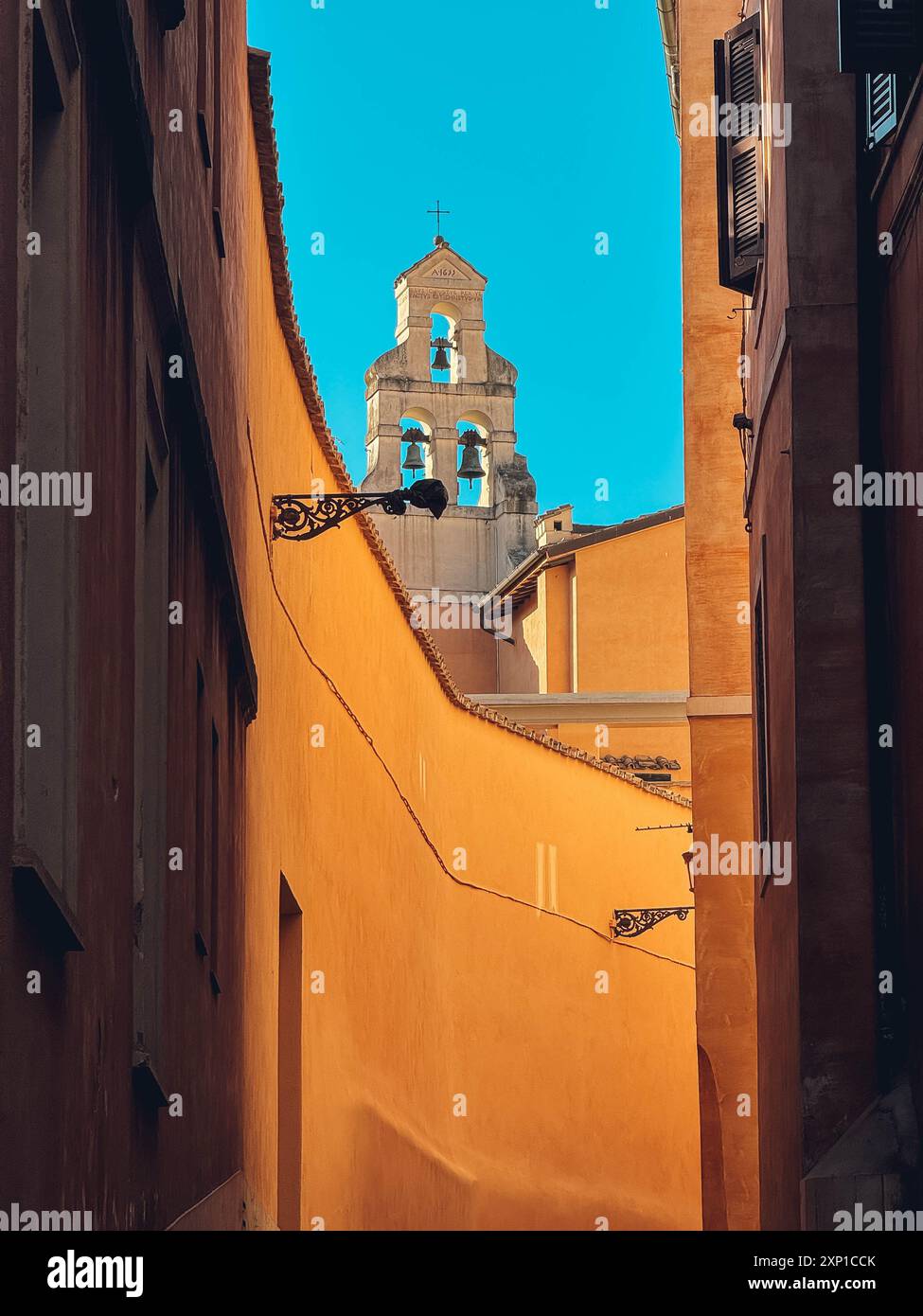 A narrow alleyway with a tall building in the background. The building ...