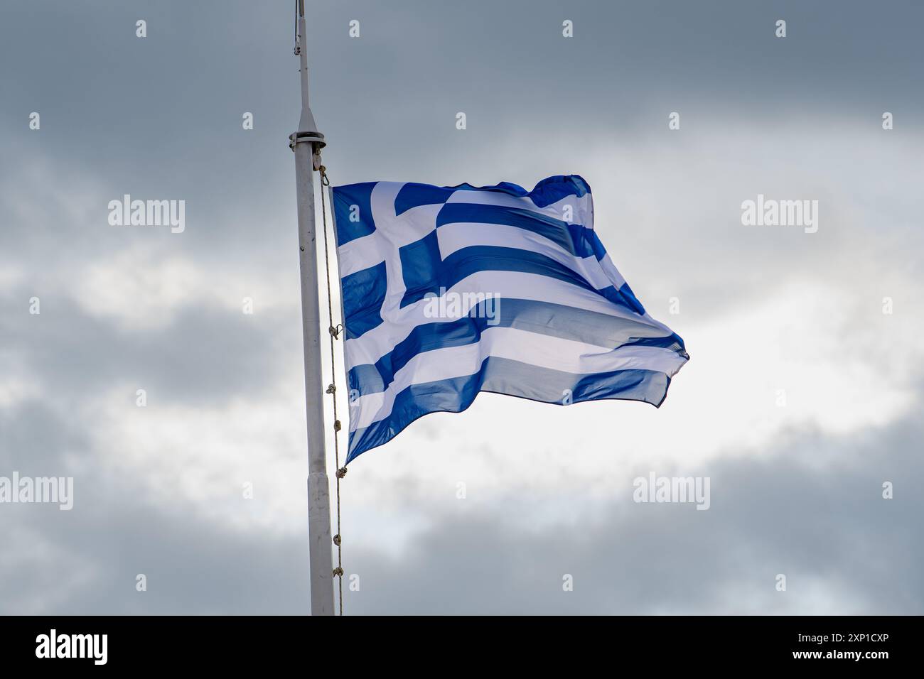 Greek Flag Waves Under Moody Skies, Symbolizing National Pride Stock ...