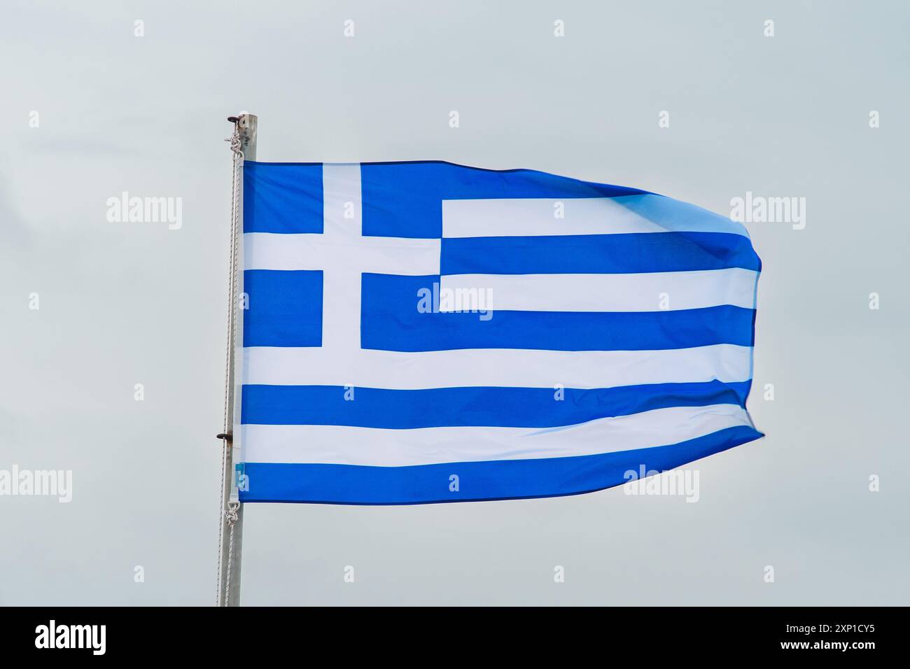 Greek Flag Waves Against Grey Sky Stock Photo - Alamy
