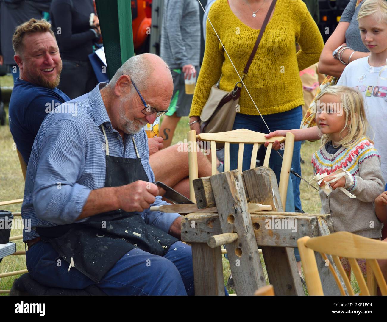 Craftsman in Wood making furniture with onlookers Stock Photo - Alamy