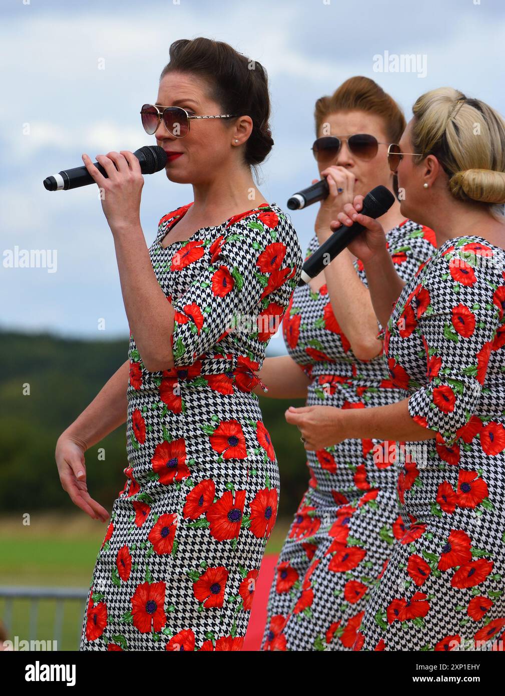 Female Singing Group performing with mics and Sunglasses Stock Photo ...