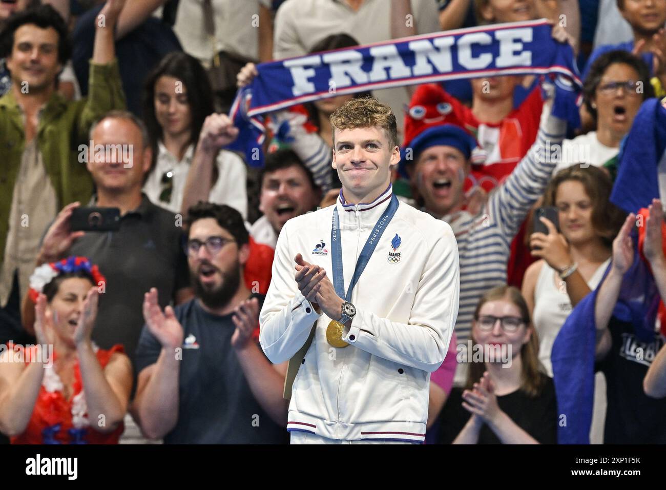 Leon Marchand of Team France celebrates after winning the gold medal in ...