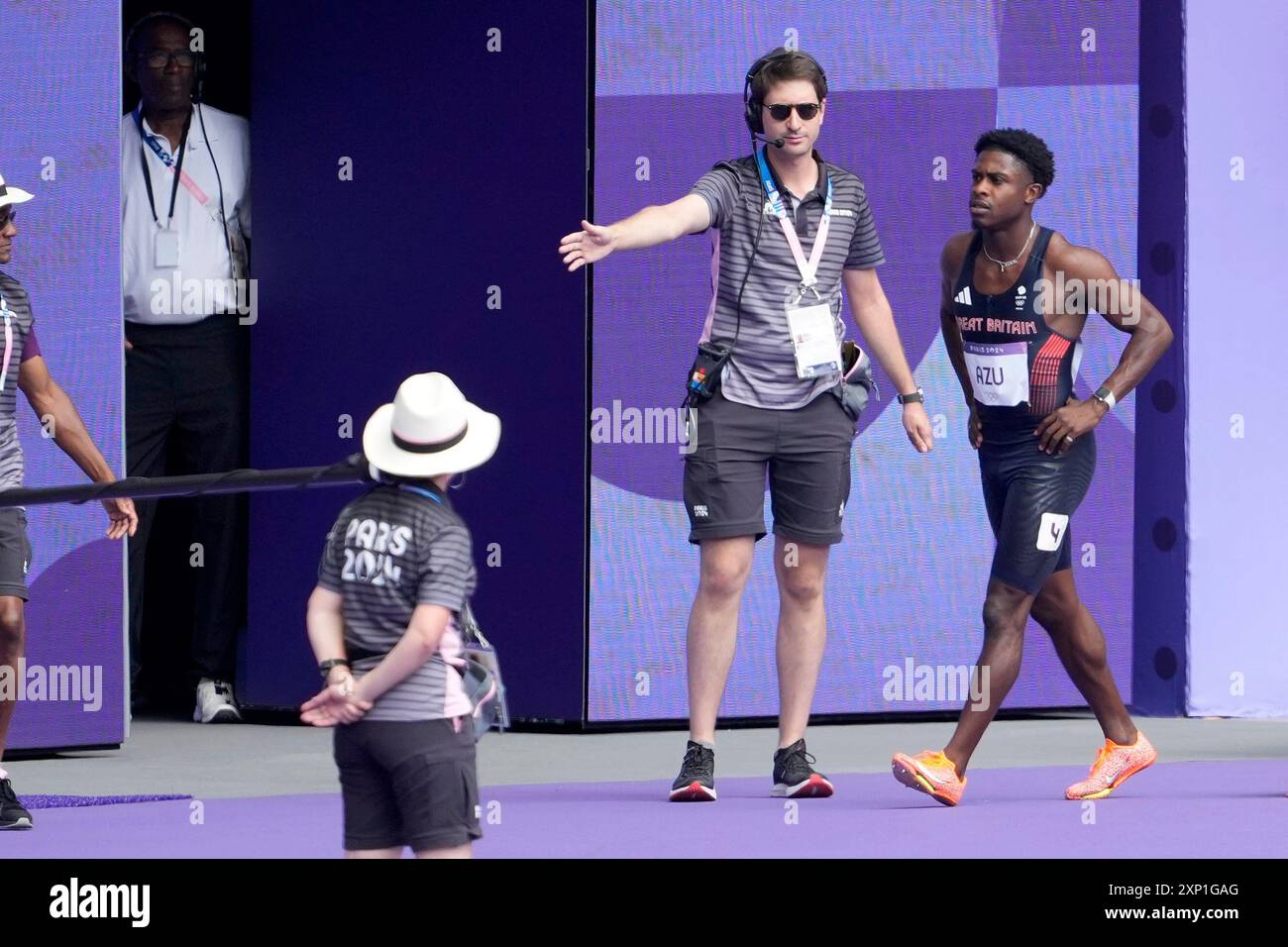 Jeremiah Azu, of Britain, leaves the track after being disqualified for ...