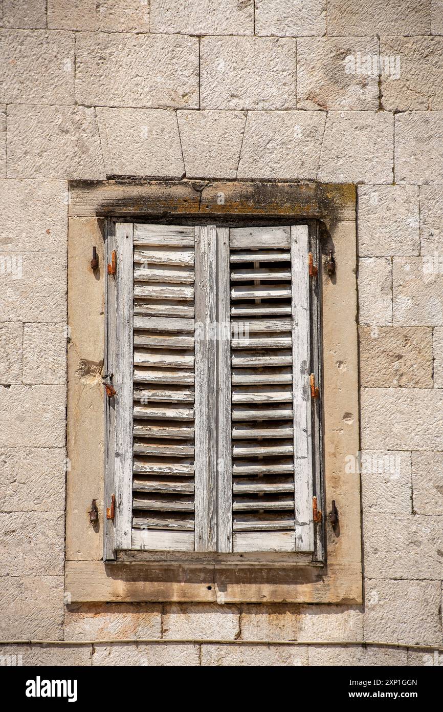 old shabby chic window with wooden shutters faded by the sun. sun ...