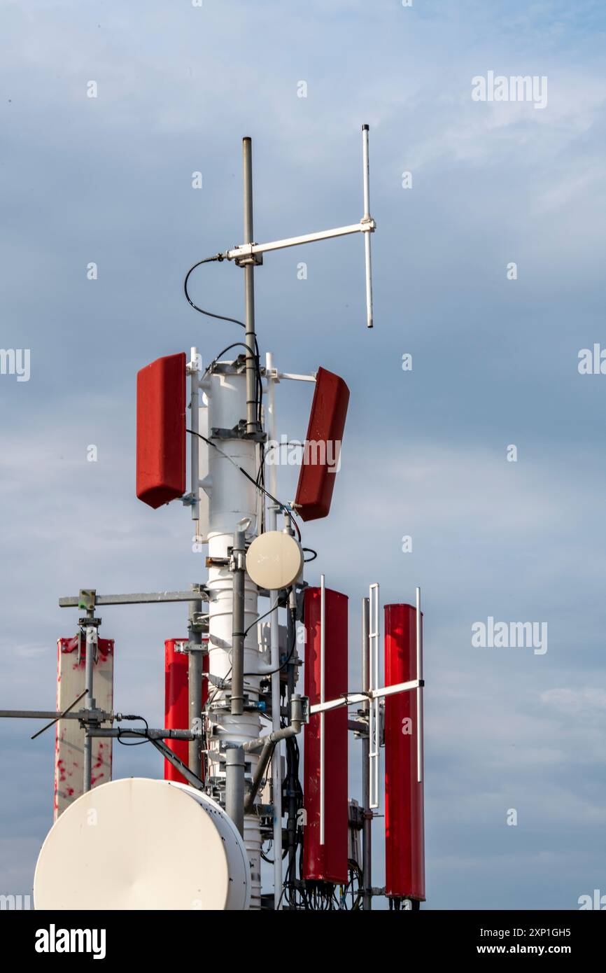 Cellular and microwave aerials on a communications network mast with a ...