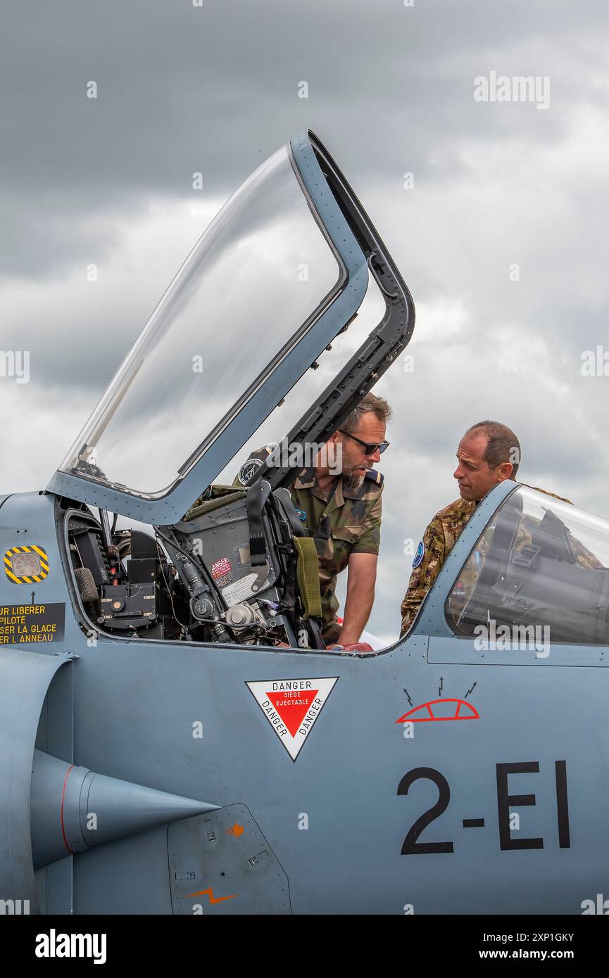 military pilot and fighter jet mechanic discussing repairs looking into ...