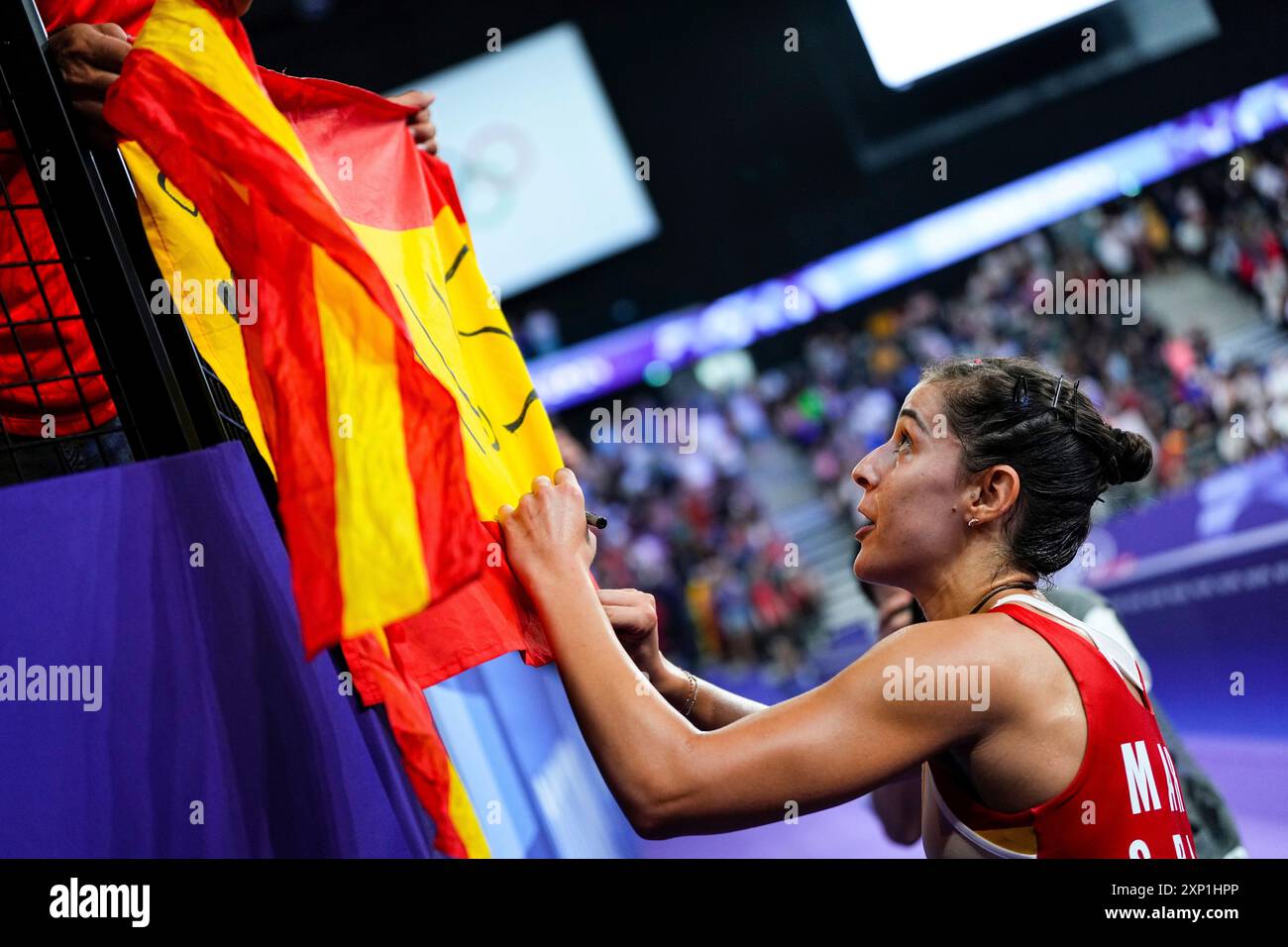 Carolina Marin of Spain signs a Spanish flag after Women's Singles ...