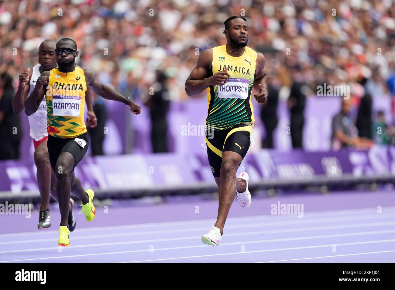 Kishane Thompson, of Jamaica, and Benjamin Azamati, of Ghana, run to ...