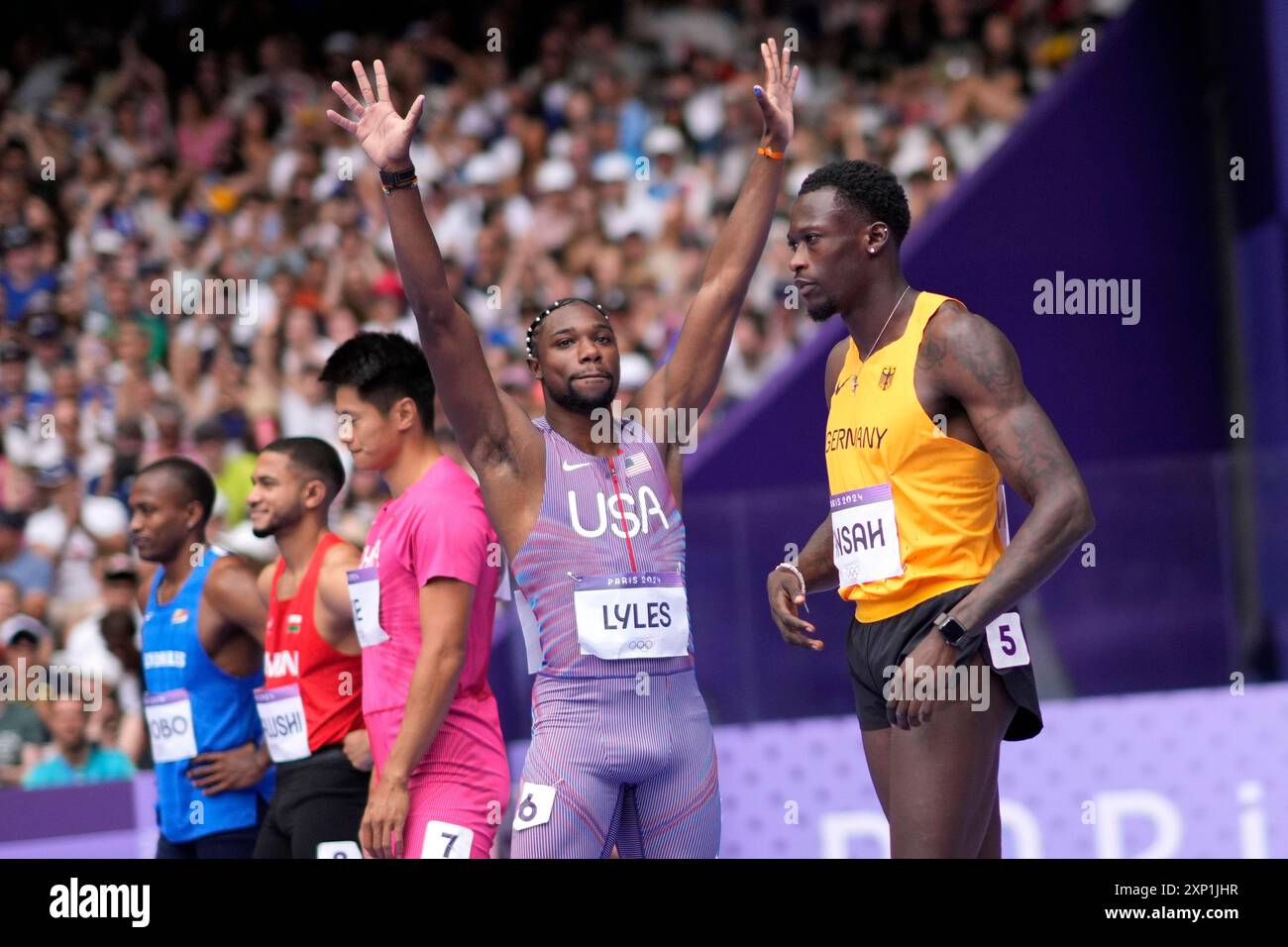 Noah Lyles, of the United States, gestures to the crowd ahead of his ...