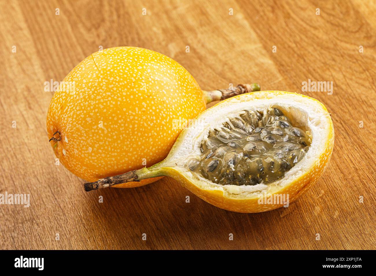 Yellow granadilla fruit with cut half Stock Photo - Alamy