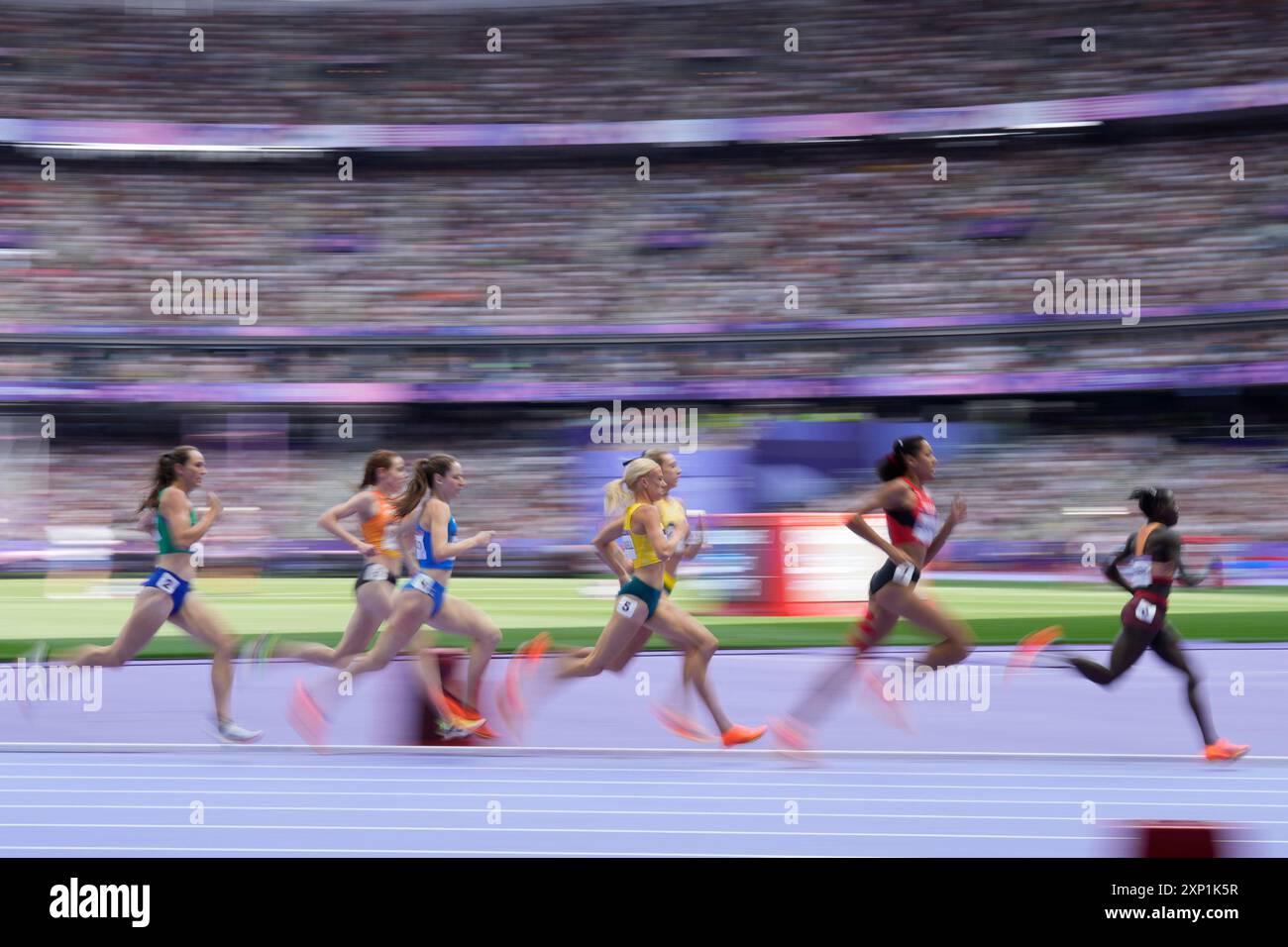 Athletes run during the women's 800 meter repechage heat 1 at the Stade ...