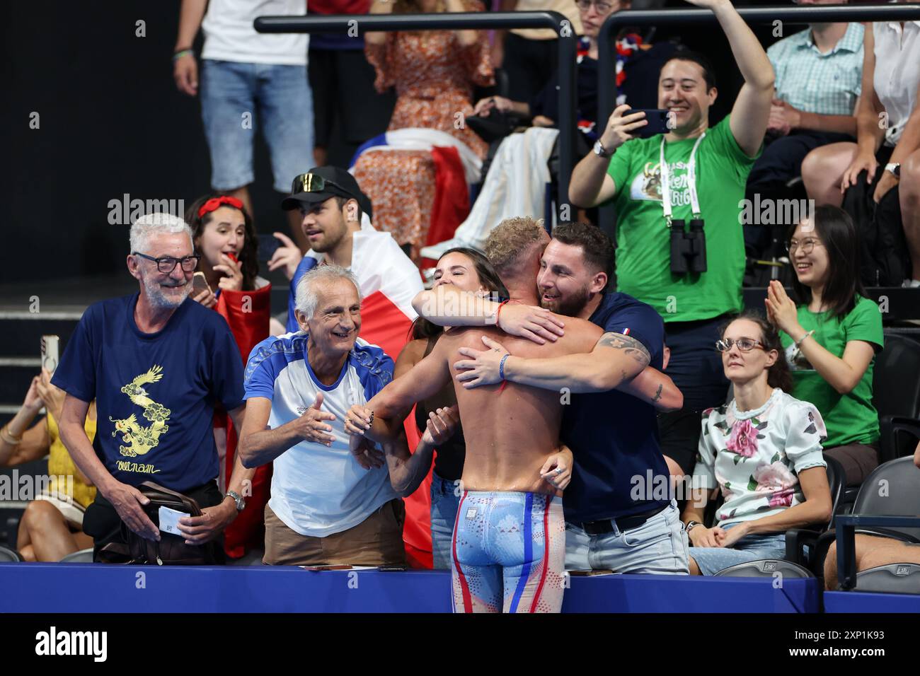 France's Damien Joly embraces with family members after the Men's 1500m ...