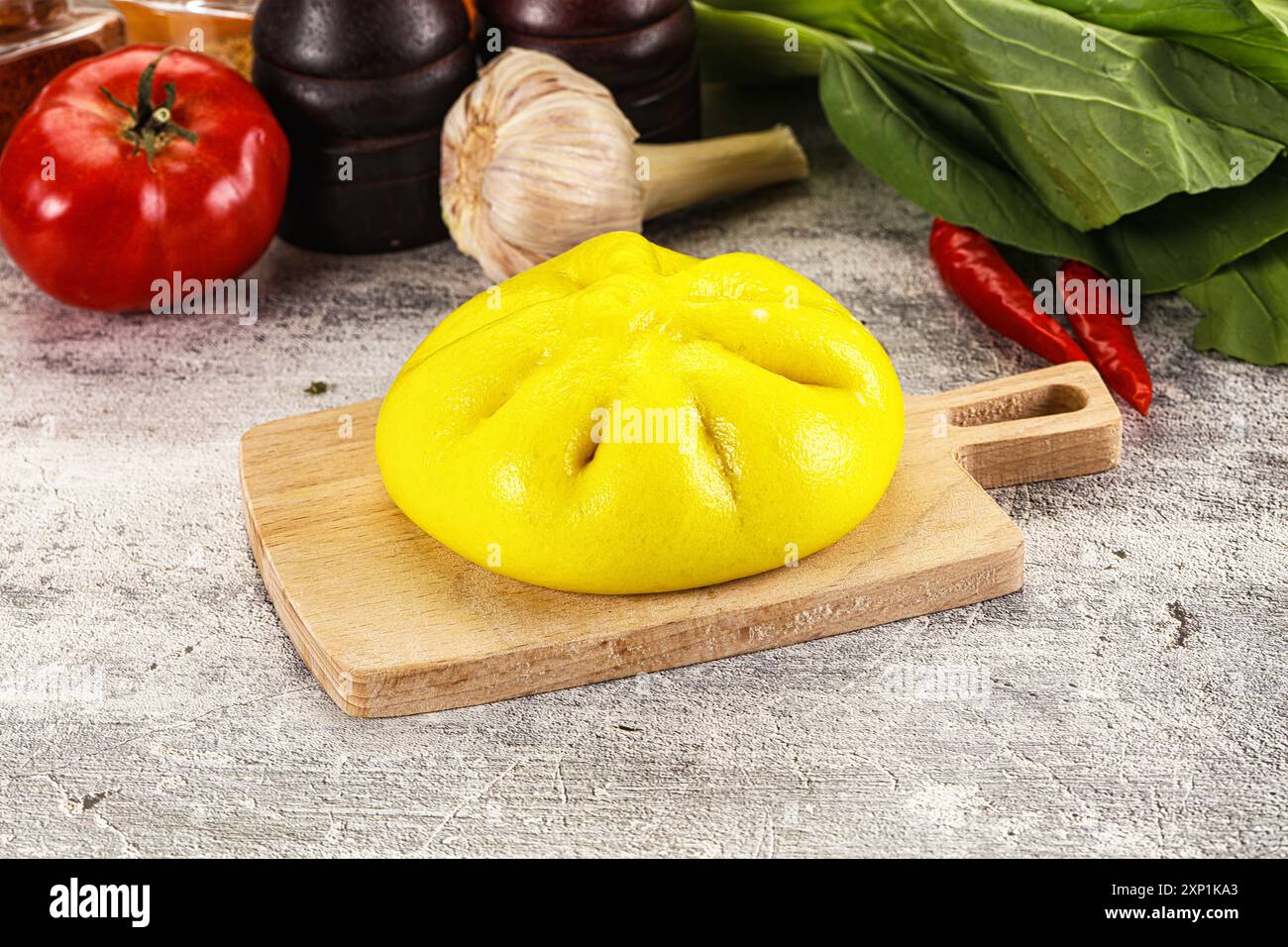 Asian stuffed steamed yellow Bun Bao Stock Photo - Alamy