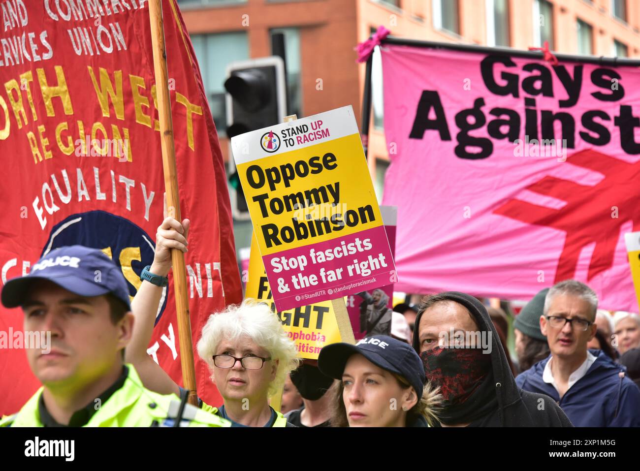 Manchester, UK, 3rd August, 2024. Person holds 'oppose Tommy Robinson ...