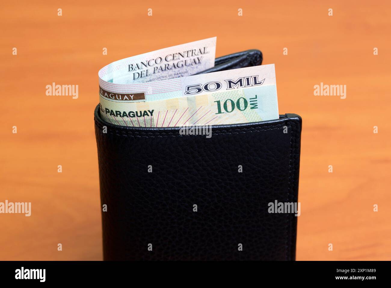 Paraguayan money - guarani in the black wallet Stock Photo - Alamy
