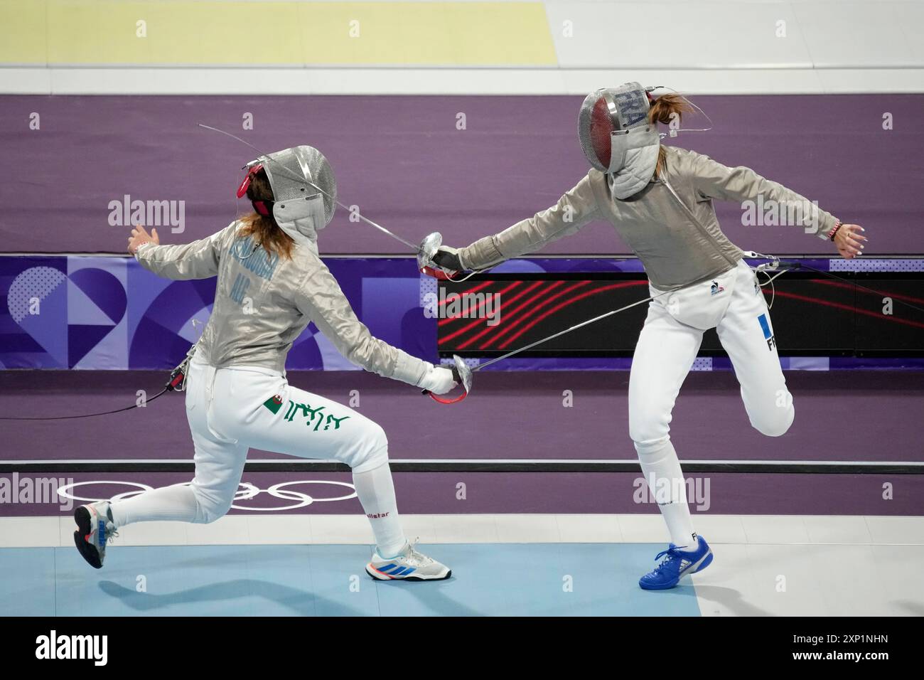 Algeria's Chaima Benadouda, left, competes with France's Manon Apithy ...