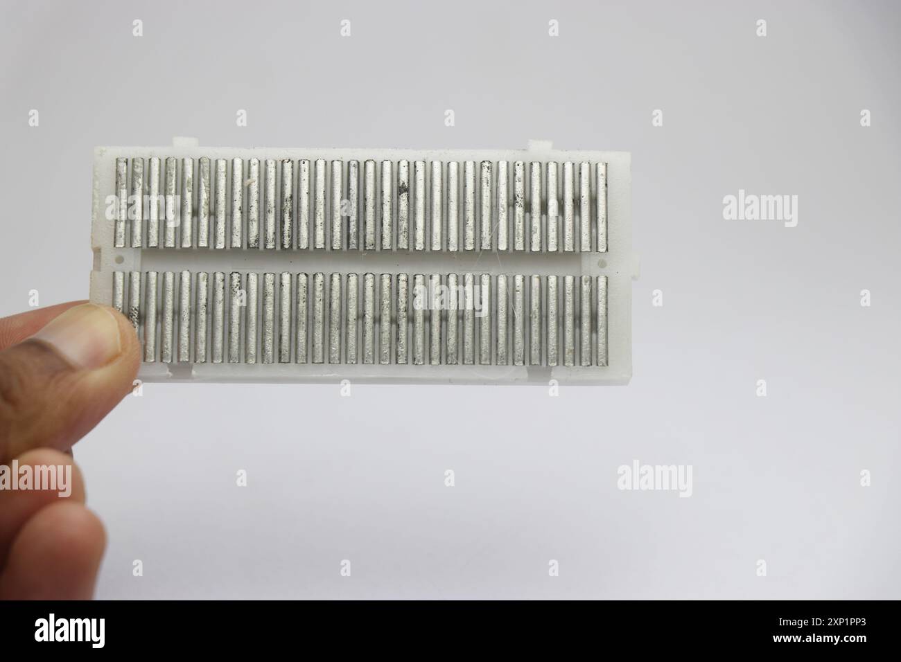 View of electrical contact strips on the back side of a breadboard used ...