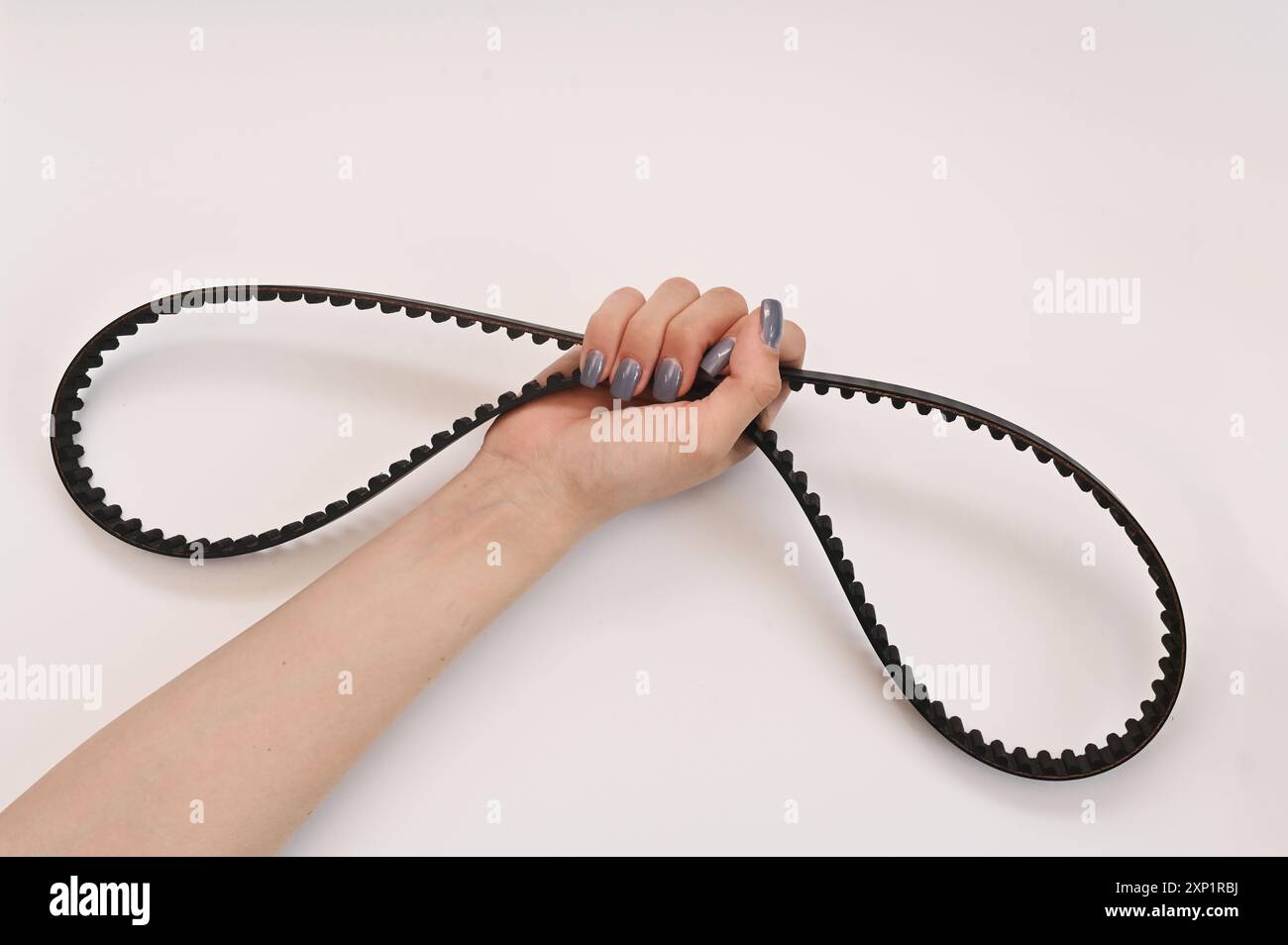 timing belt in a woman's hand on a white background Stock Photo - Alamy
