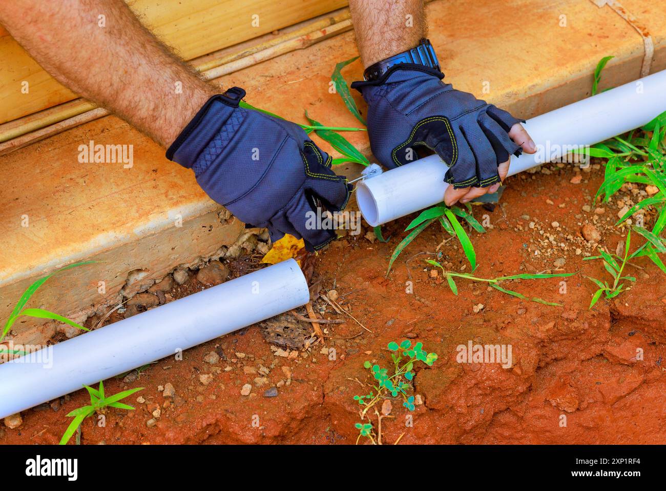 Plumber installing plastic PVC pipes for laying of water supply line ...