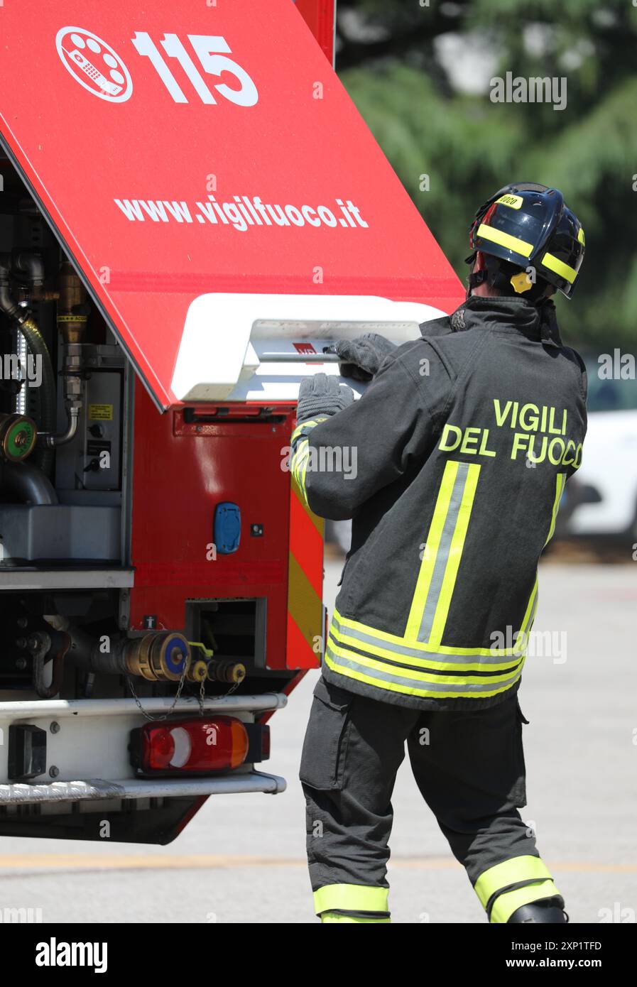 Vicenza, VI, Italy - May 23, 2024: Firefighter opening the tailgate of ...