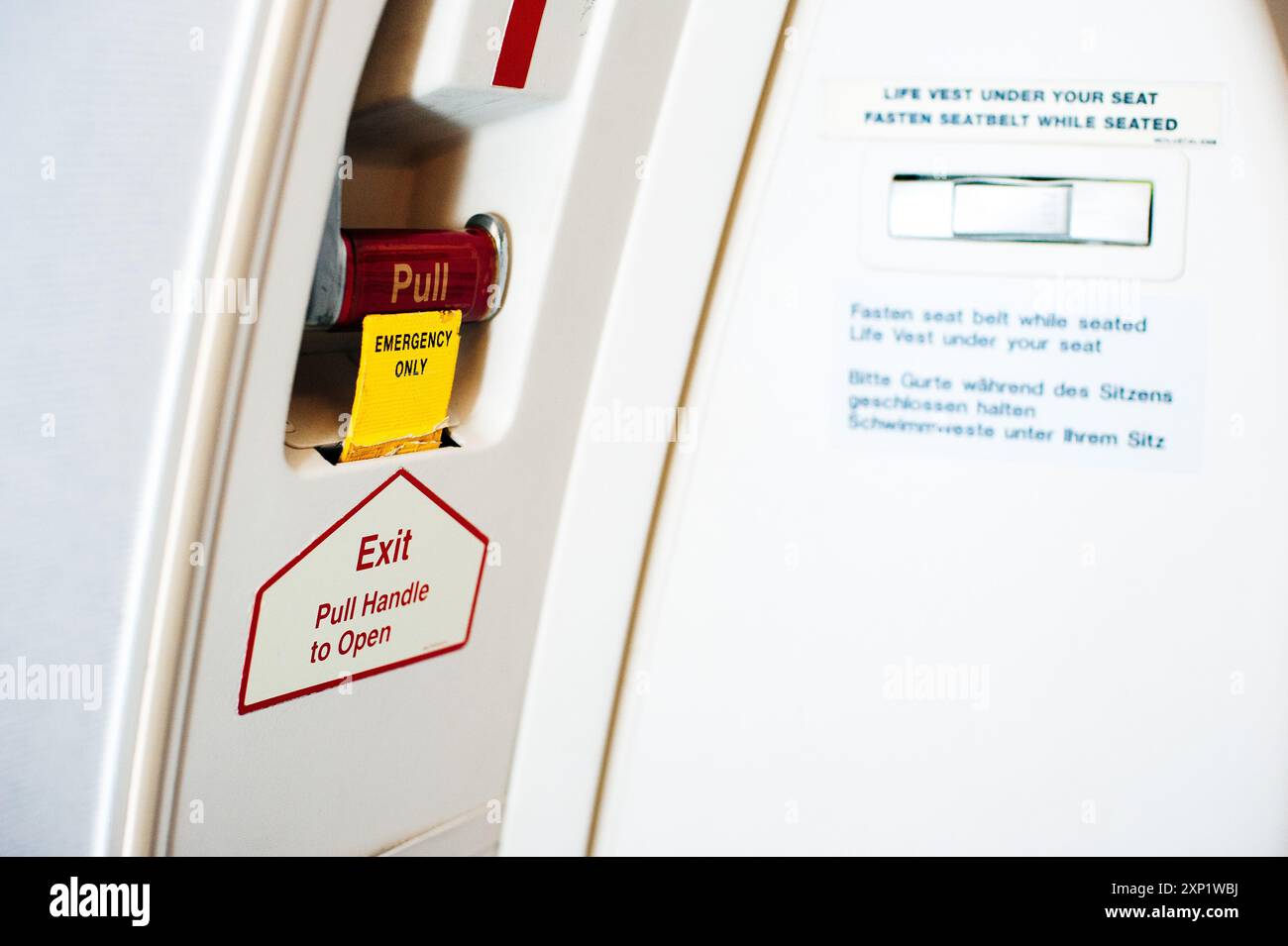Emergency exit on the plane. pull handle to open. High quality photo ...