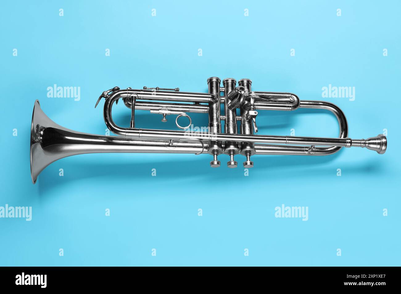 One trumpet on light blue background, top view Stock Photo - Alamy