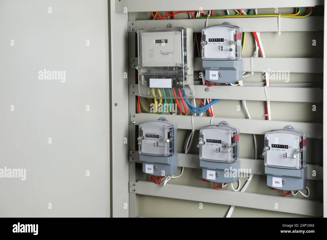 Electric meters and wires in fuse box, space for text. Energy measuring ...