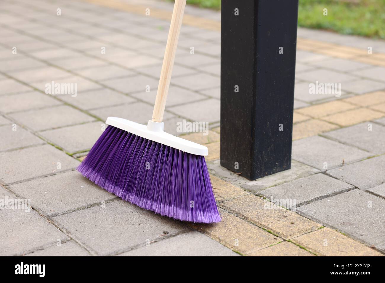 One bright cleaning broom on pavement outdoors Stock Photo - Alamy