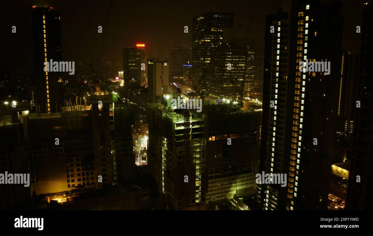 Building skyscraper at construction process during night. Construction ...