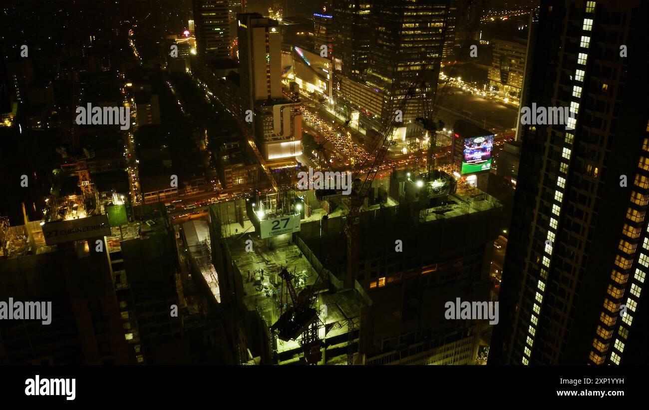 Building skyscraper at construction process during night. Construction ...