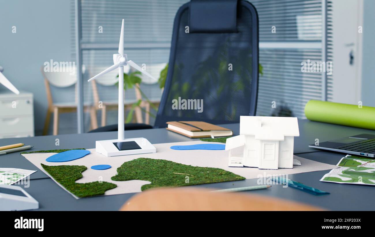 Engineer's workplace with computer monitor and wind turbine model in ...