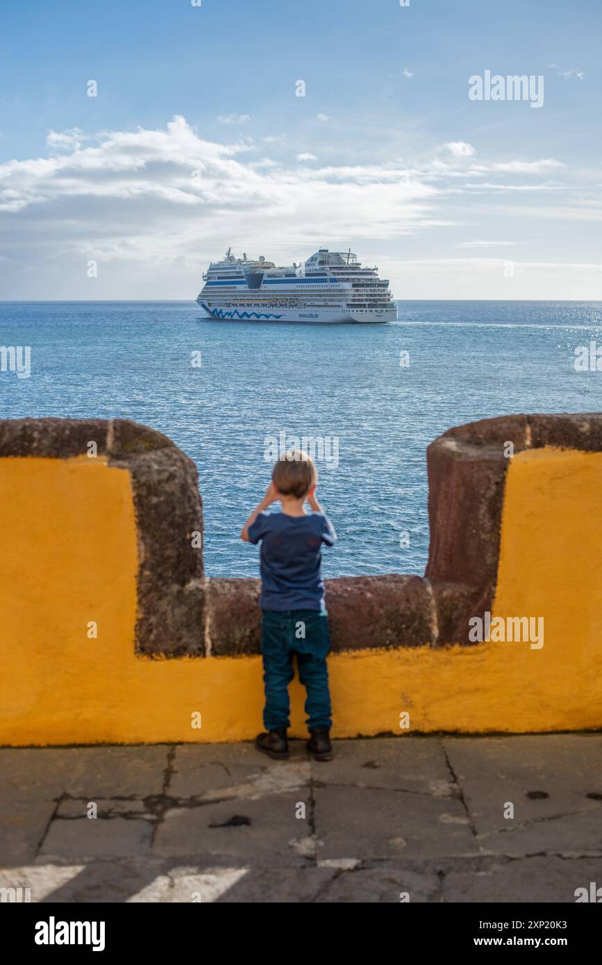 Anonymous Child gazing at a the AIDA cruise ship from a viewpoint in ...
