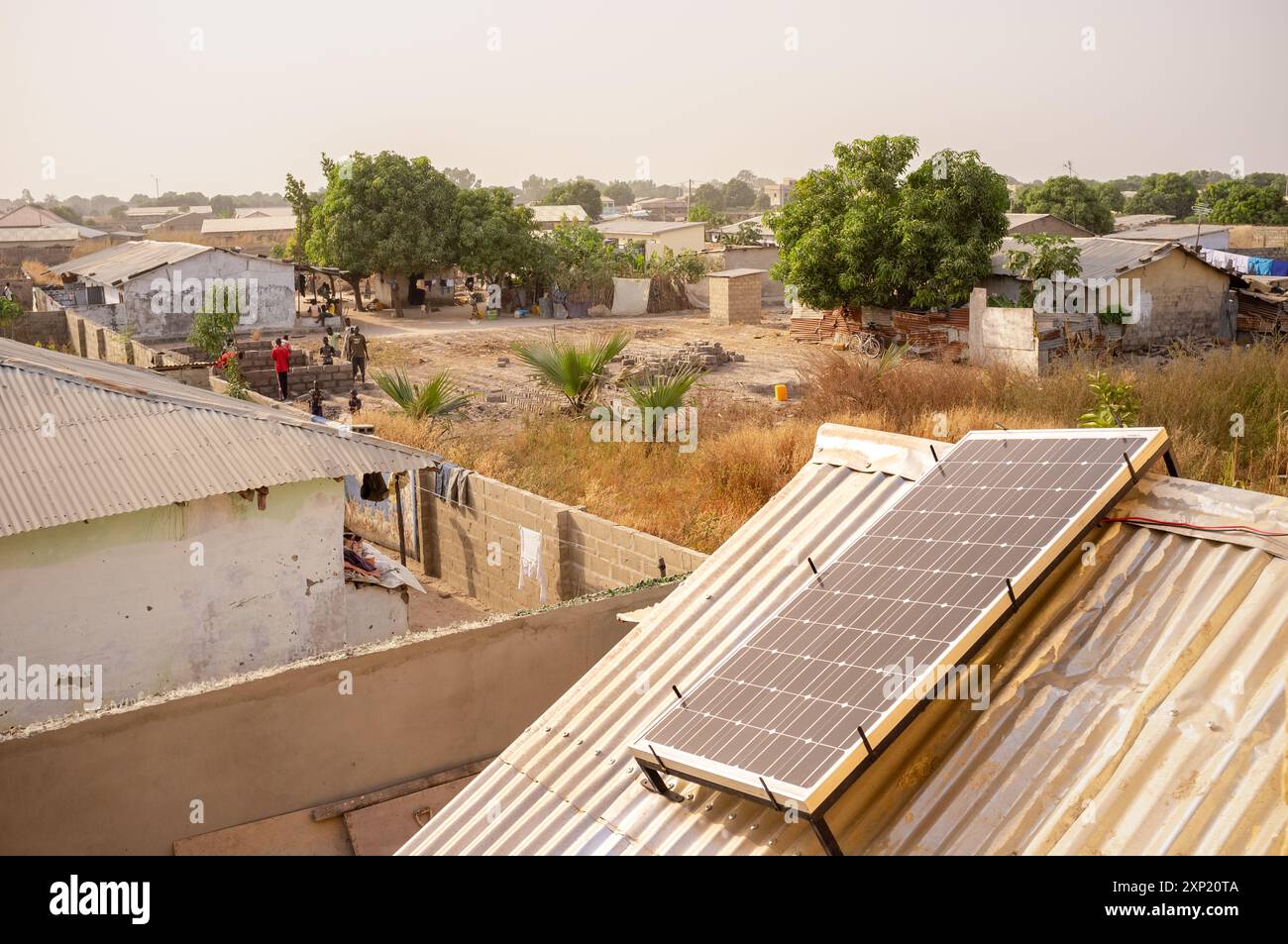 View of a rural village in Gambia, West Africa, featuring solar panels ...