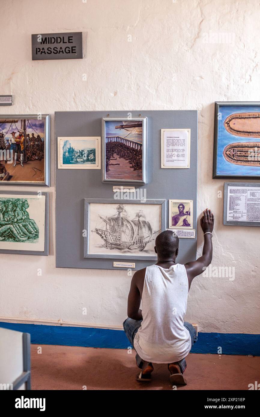 A man kneels and reflects on the history of slavery at the Middle ...