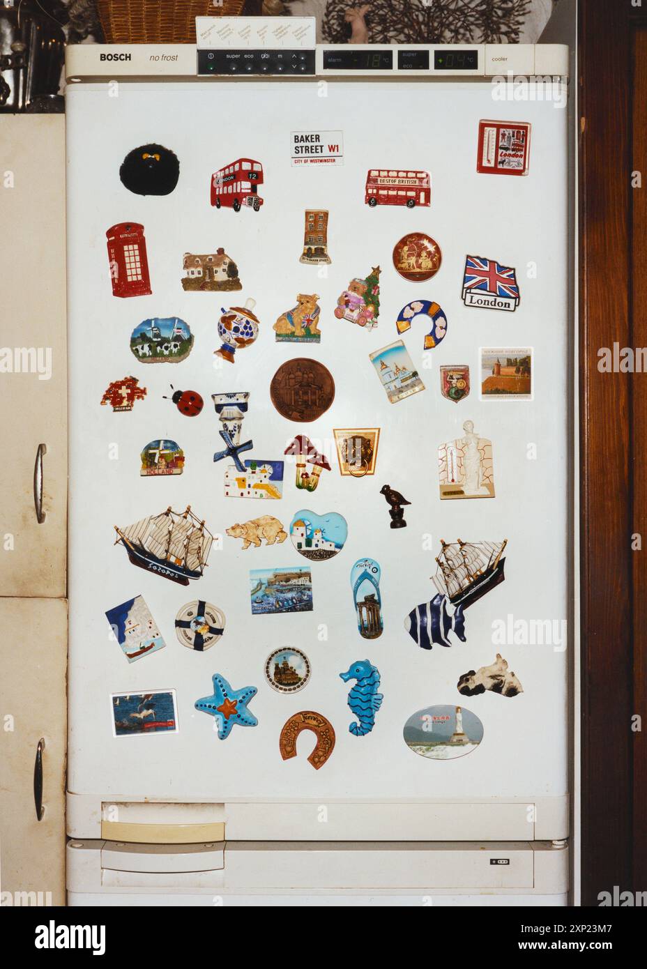 A collection of vibrant souvenir fridge magnets from various places ...
