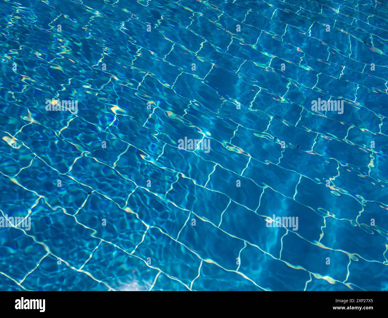 Swimming pool background with distorted tiles below water surface Stock ...