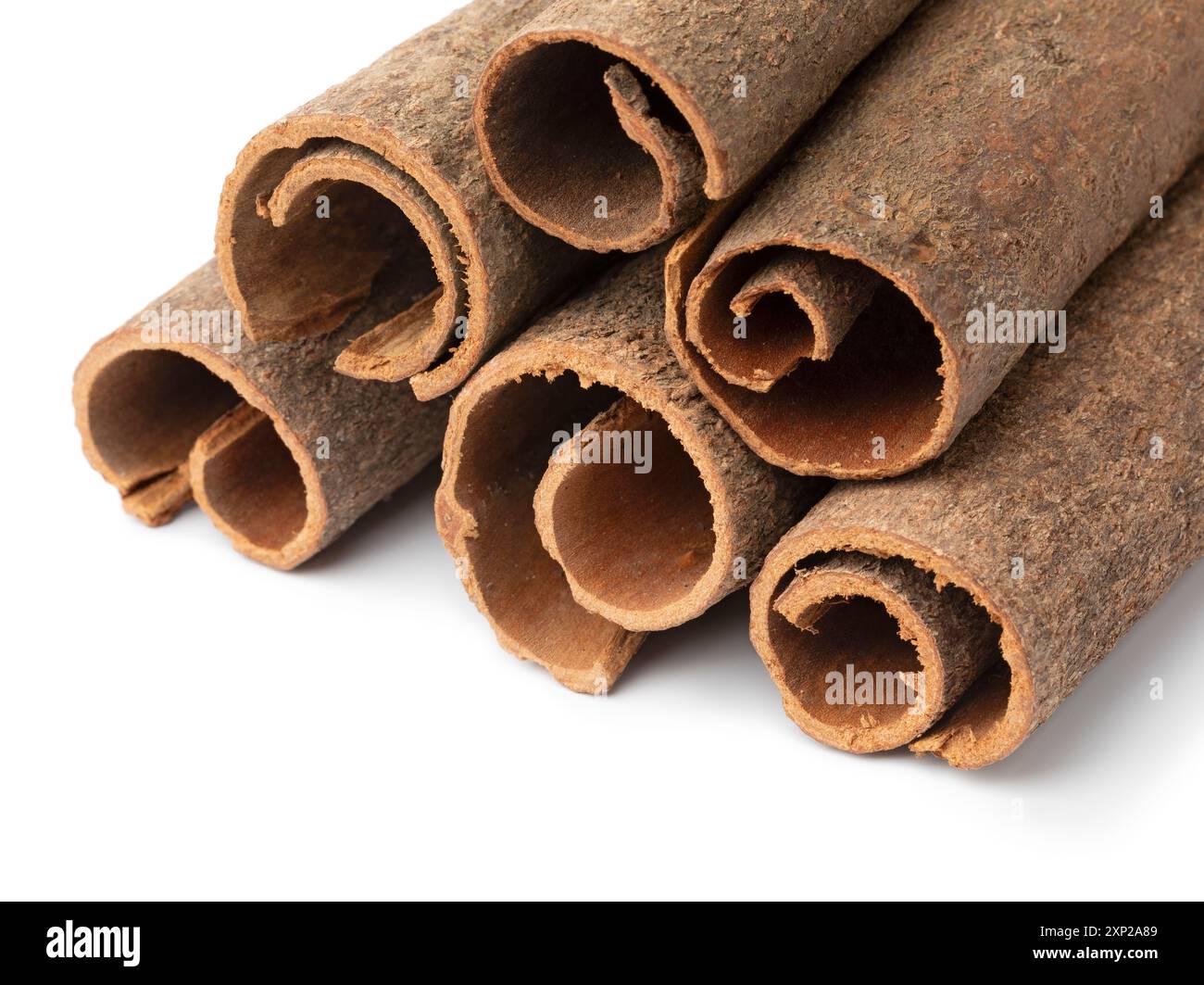 Pieces of dried Chinese cassia cinnamon close up on white background ...