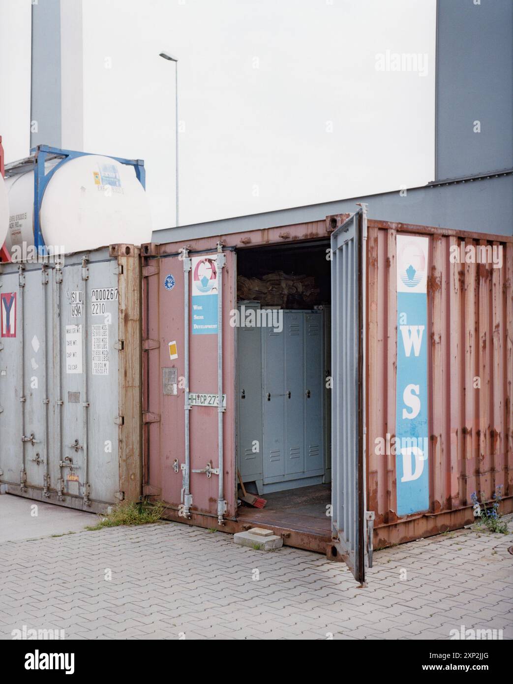 Industrial shipping containers with open doors revealing storage ...
